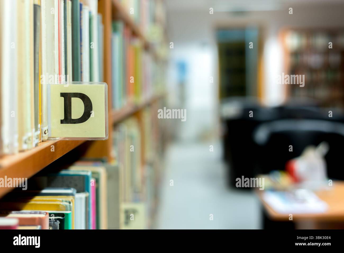 Library bookshelf extreme closeup with letter sign Stock Photo - Alamy