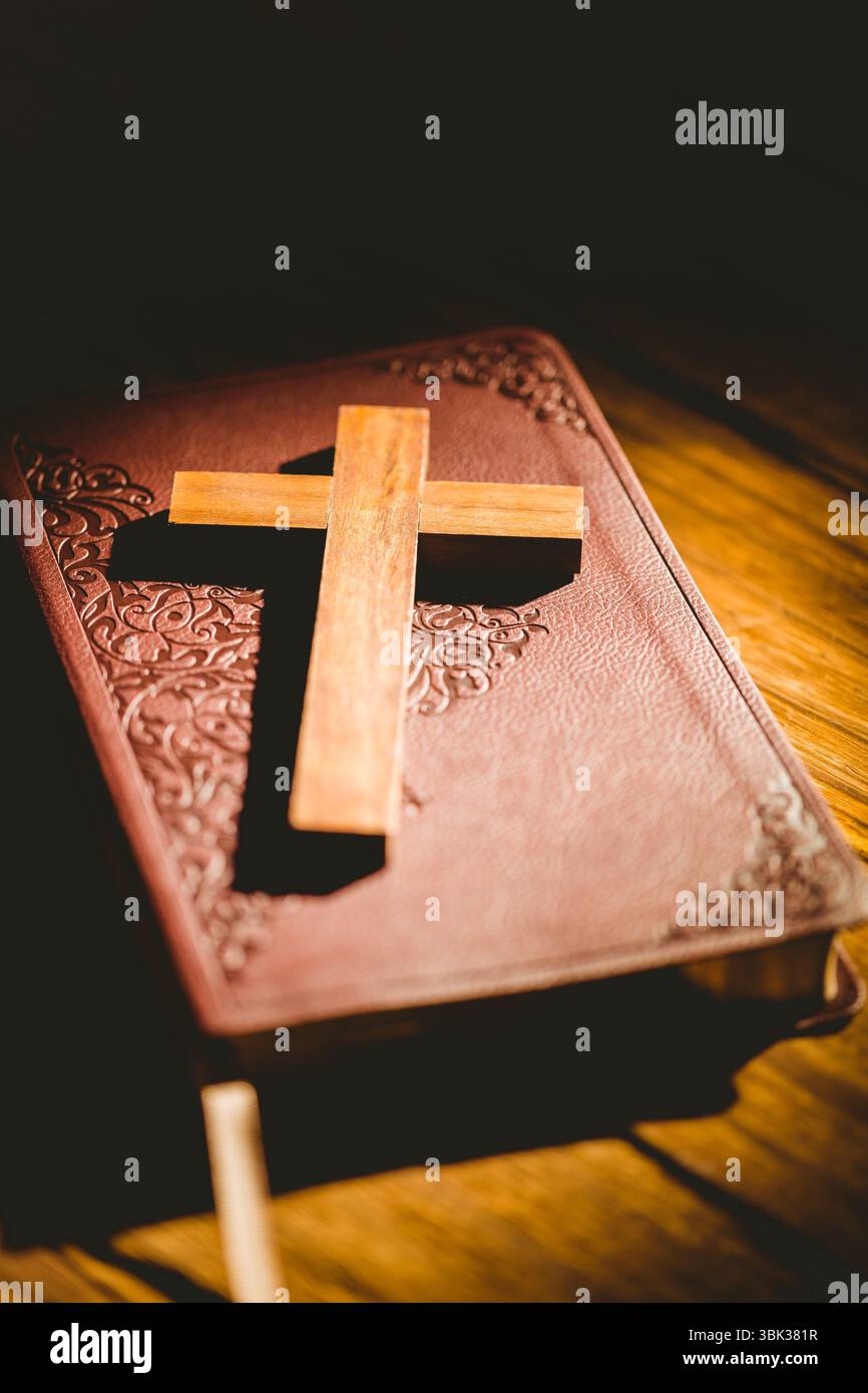 Wooden cross on bible at desk Stock Photo - Alamy