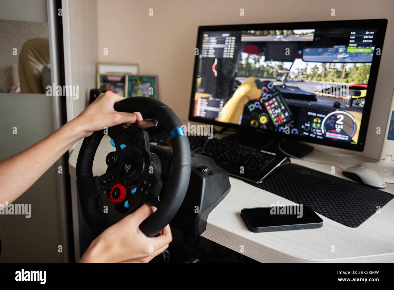 Kyiv, Ukraine - June 17, 2025: Hands controlling racing simulator setup ...