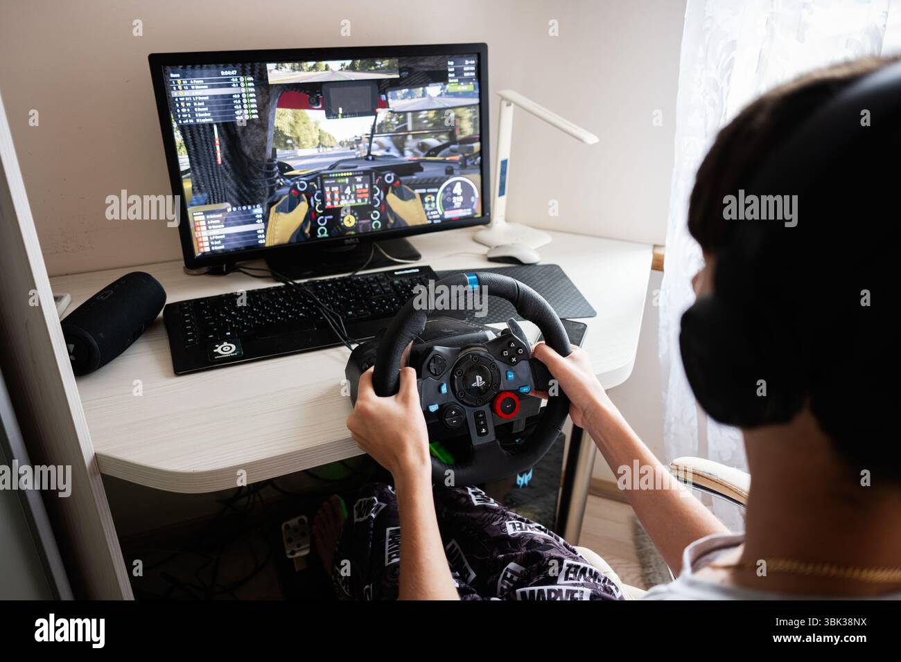 Kyiv, Ukraine - June 17, 2025: Person immersed in a racing video game ...