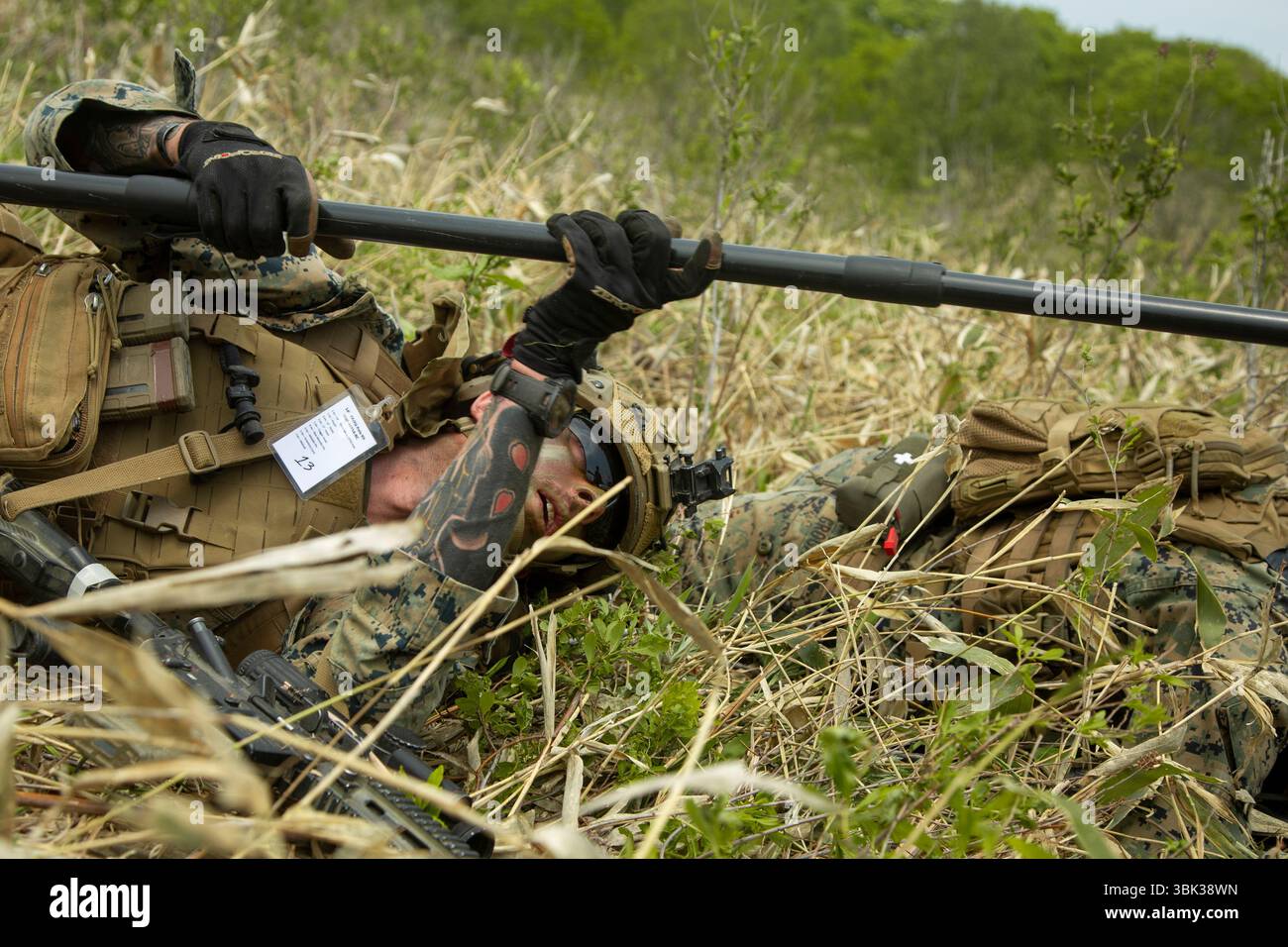 U.S. Marine Corps Lance Cpl. Kirk Doyle clears concertina wire during a ...