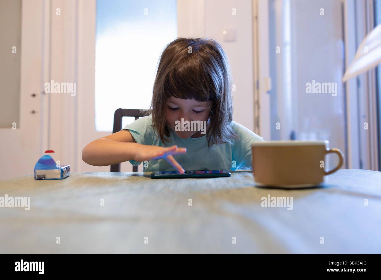 A kid learning how to read on her smart phone Stock Photo - Alamy
