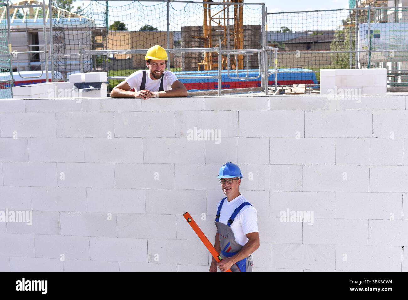teamwork on the construction site - bricklayer build a family home ...