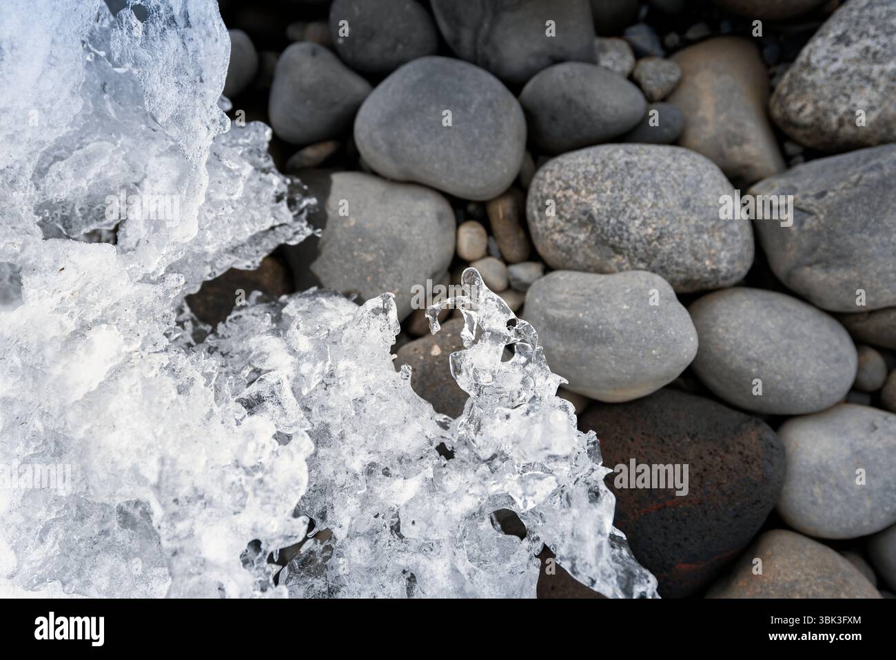 Ice and stones frozen togather at the shore hi-res stock photography ...