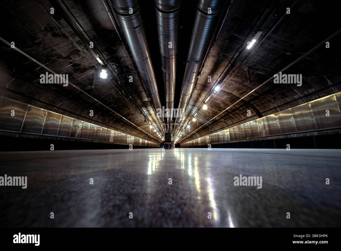 Underground tunnel for the subway leading deep down Stock Photo - Alamy