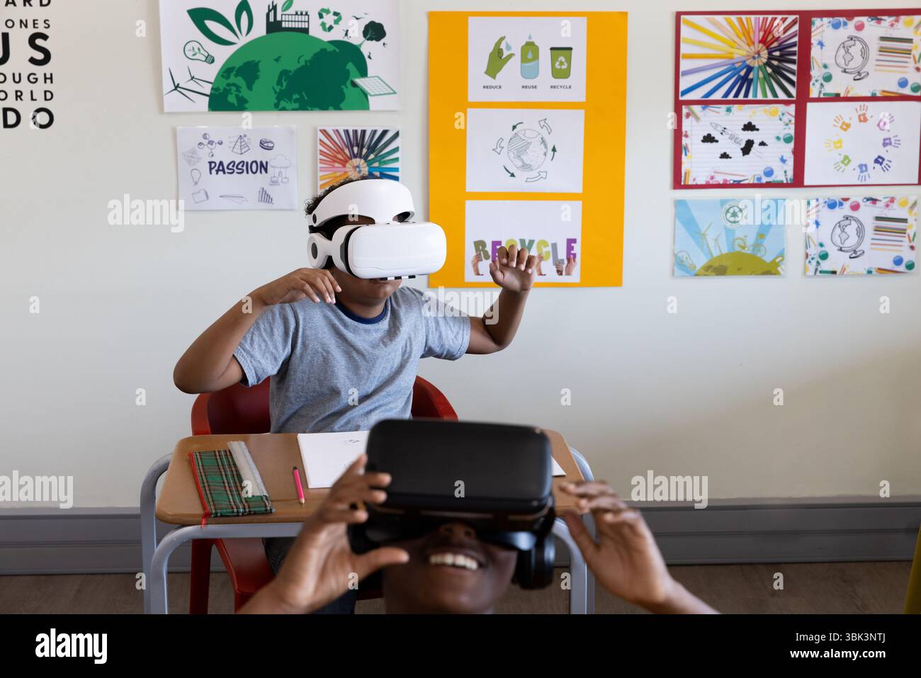 Diverse students using VR headsets in classroom, exploring virtual ...