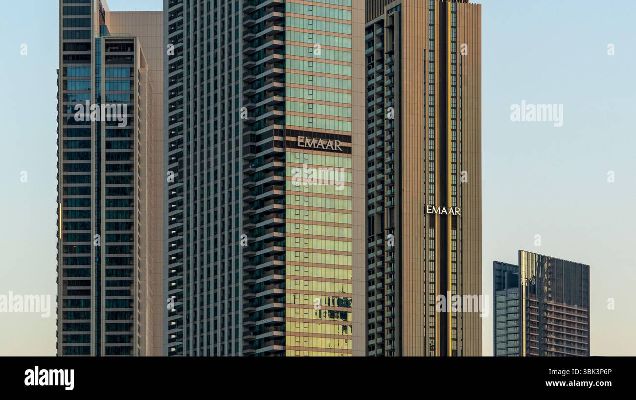 Modern skyscrapers with prominent EMAAR logos under a clear sky, Emaar ...