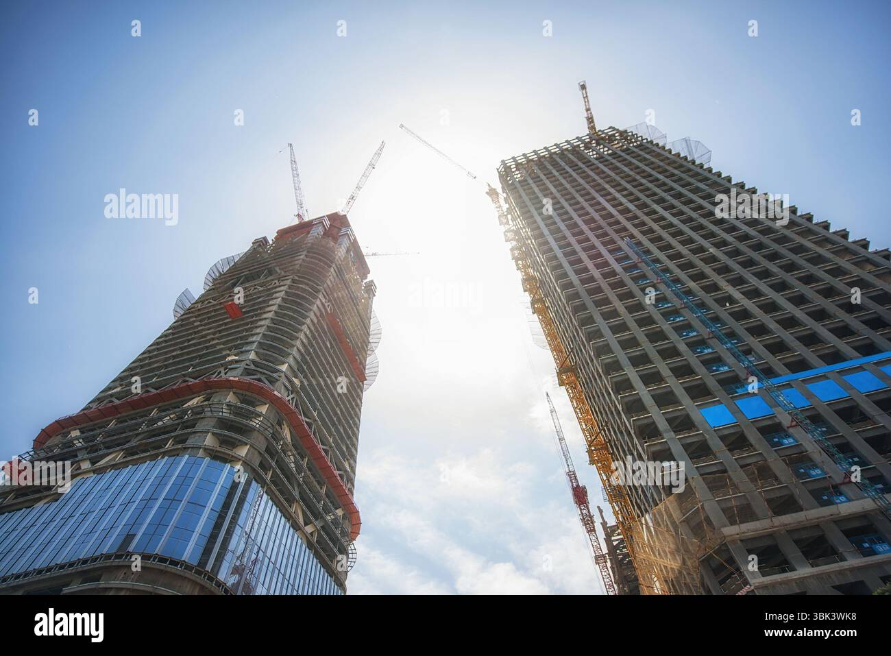 Construction of skyscrapers under blue sky angle shot Stock Photo - Alamy
