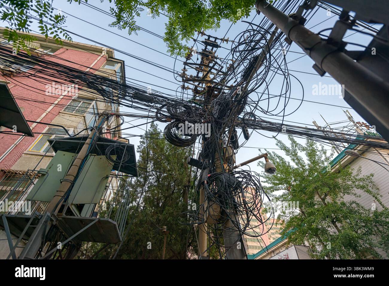 Large mount of power cables on wooden pylon in China Stock Photo - Alamy