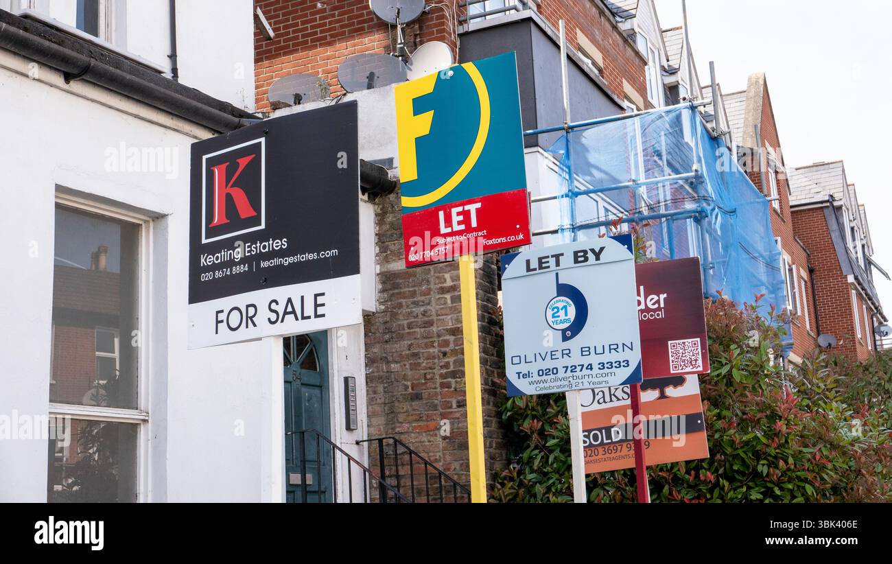 Estates Agent signs along residental street in London, England. Photo ...