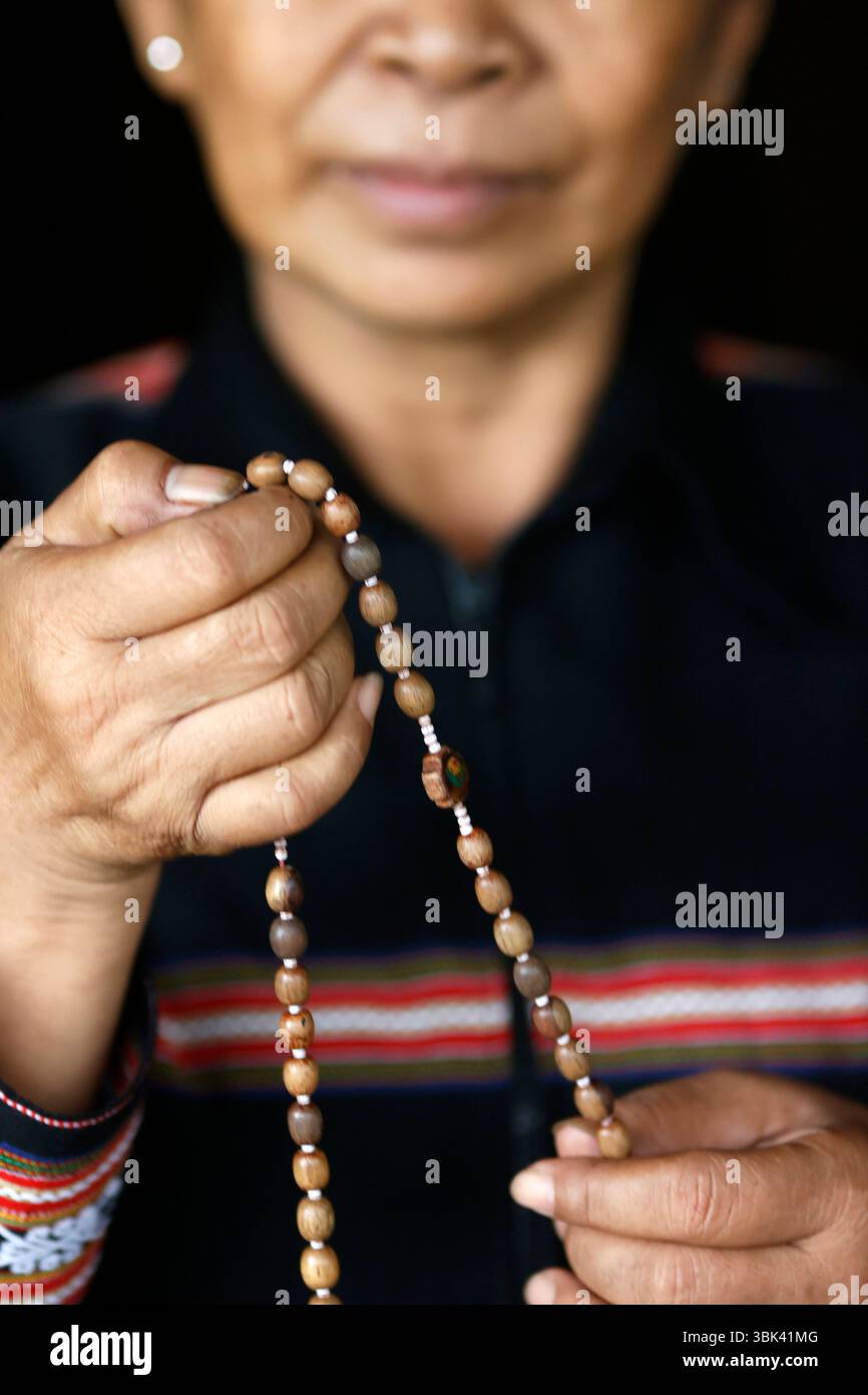 Bahnar woman from ethnic minorities praying the rosary in church ...