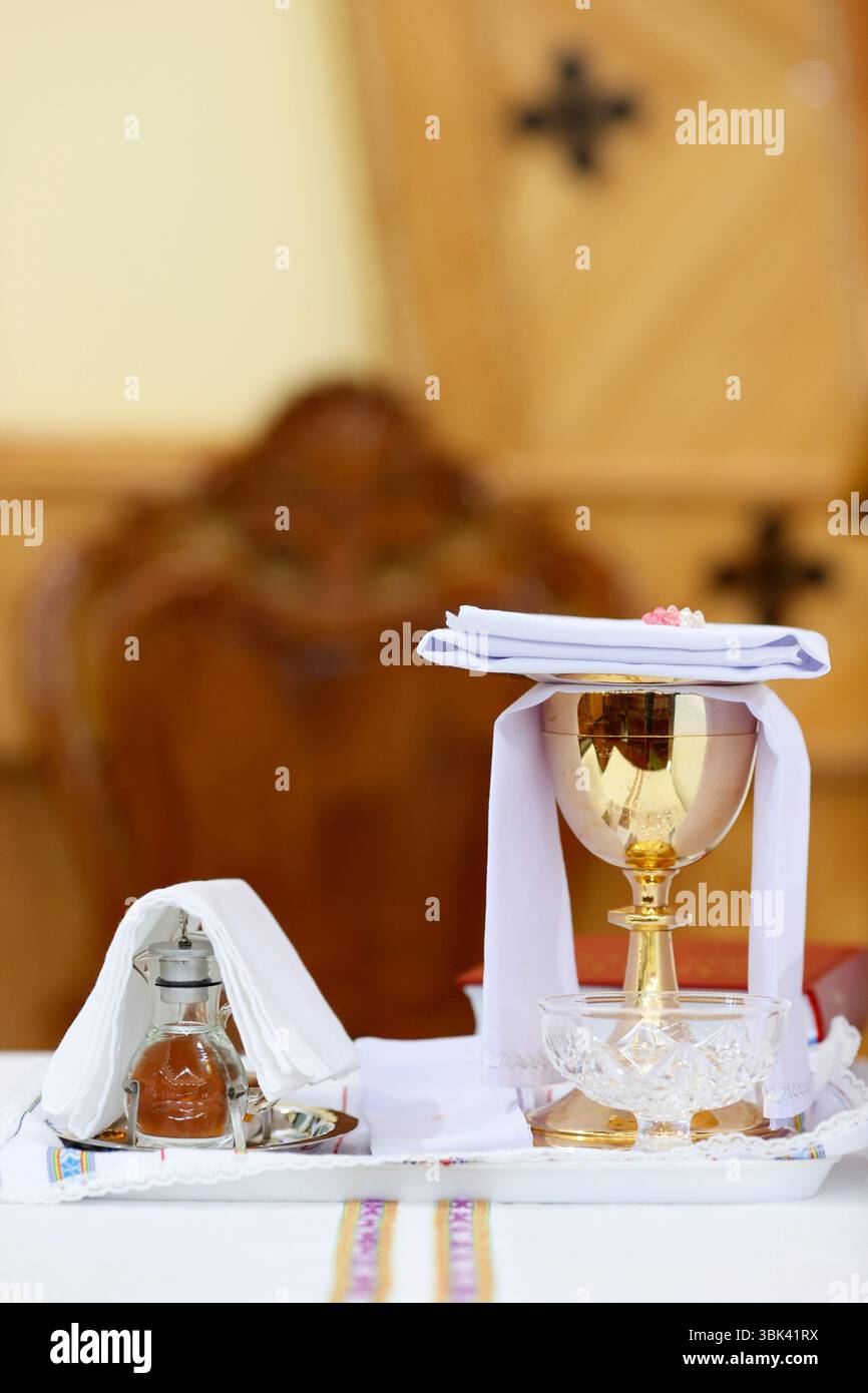 Catholic church. Sunday mass. Eucharist table with chalice and cruets ...