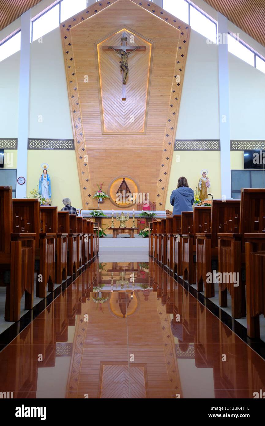 Catholic woman praying alone in a church. Mang Den Virgin Mary ...