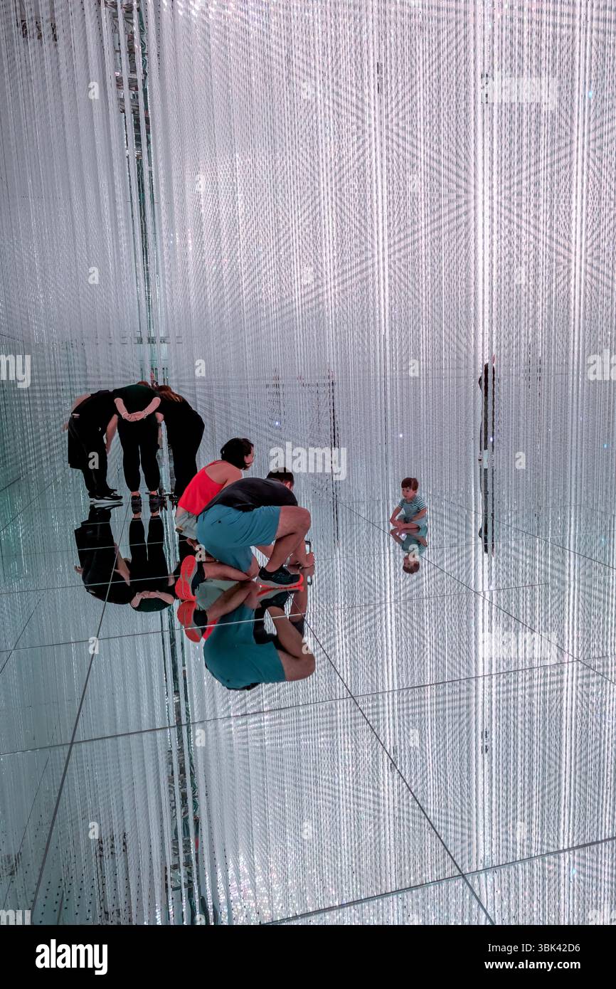 Visitors exploring and enjoying digital art exhibition at teamLab ...