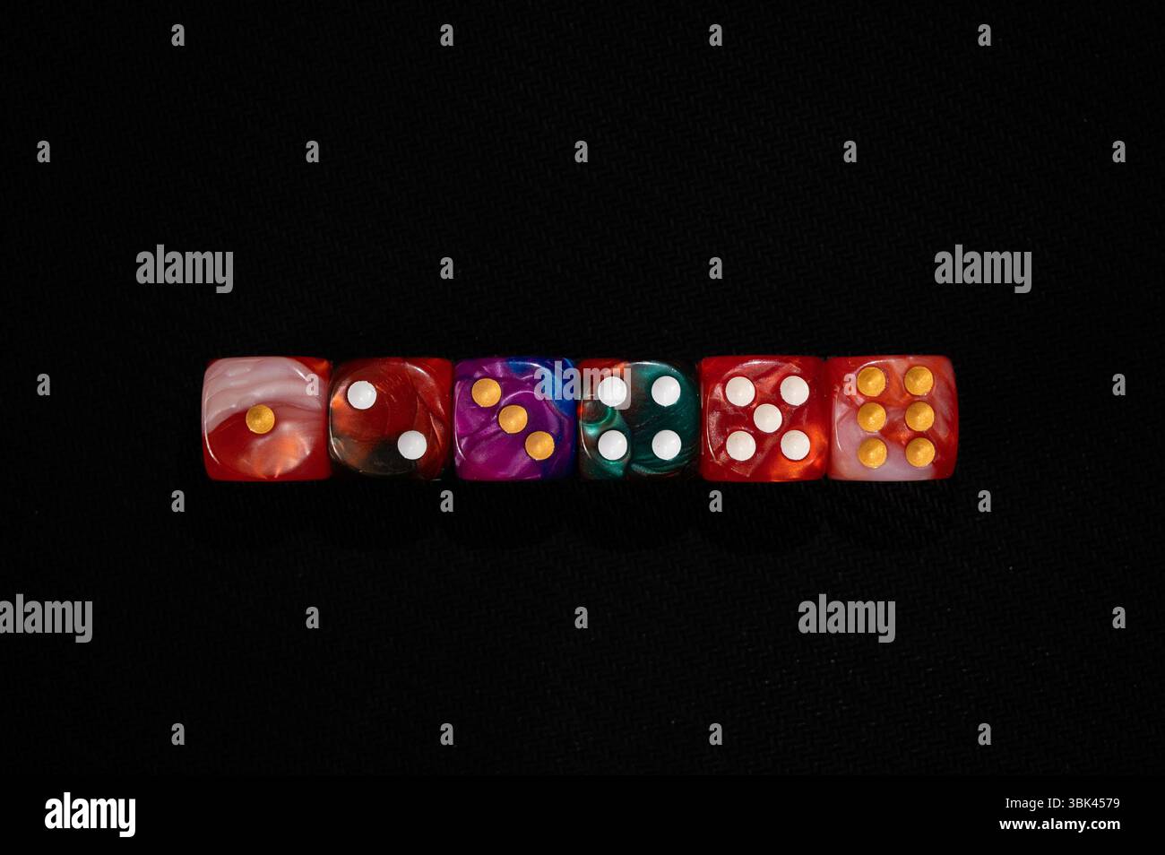 A vibrant, top-down photograph of six marbled D6 dice lined up in ...