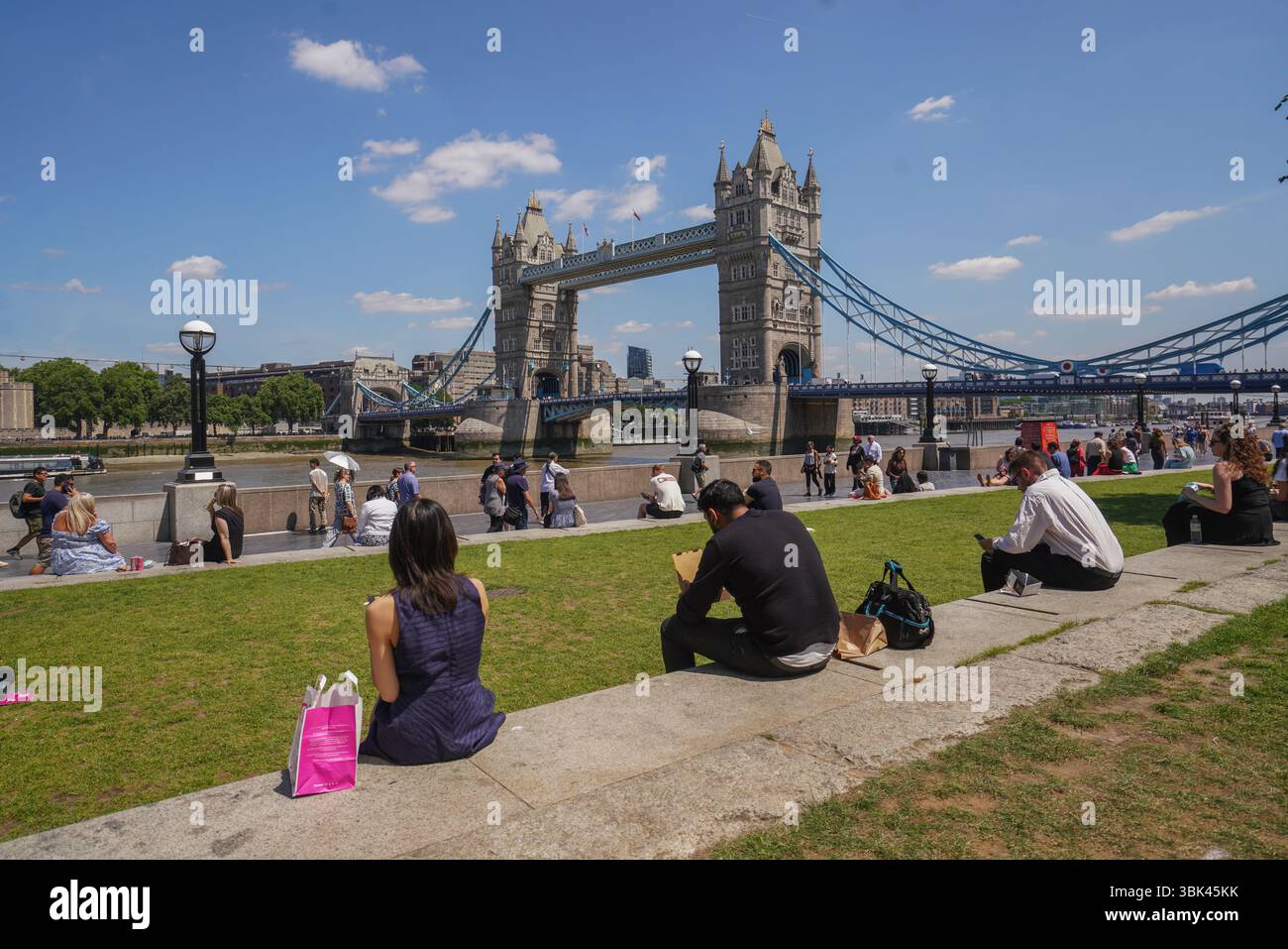 London, UK. 18 June 2025. People relaxing in the sunshine in Potters ...