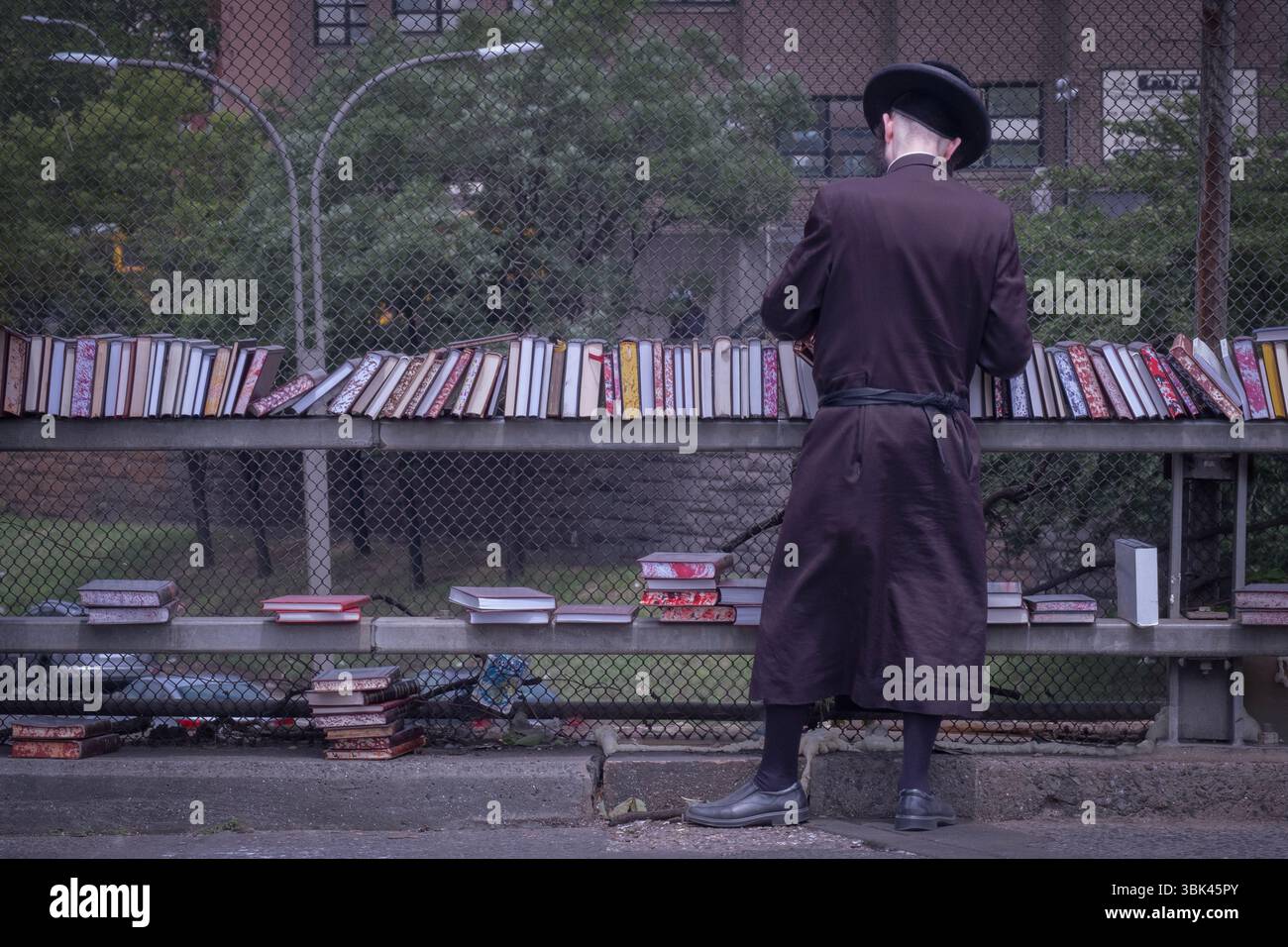 An anonymous orthodox Jewish man shops for religious books at a pop up ...