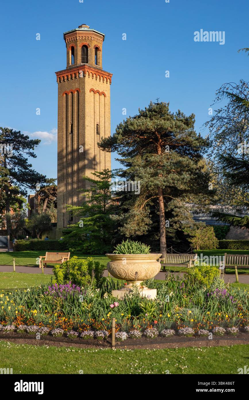 Former chimney for the palm house boilers with a formal planting bed, Kew Gardens, London, UK ...