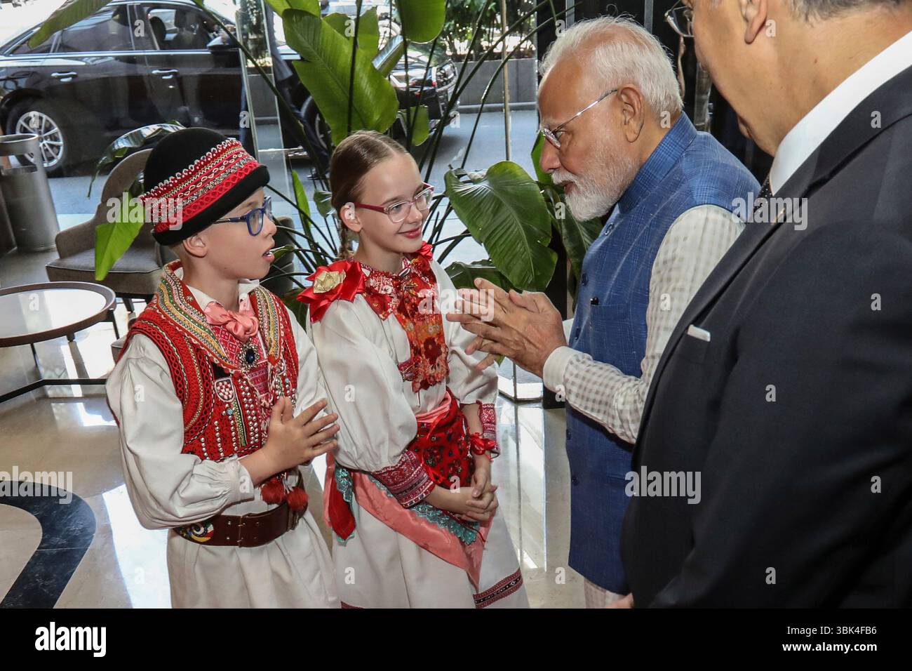 India's Prime Minister Narendra Modi greets children wearing ...