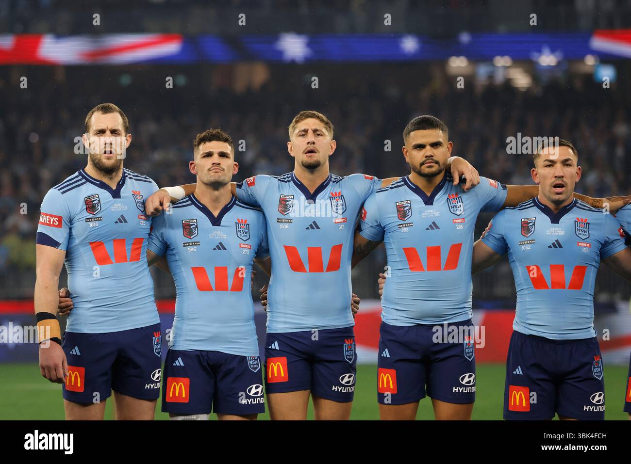 Blues players sing the national anthem before the State of Origin game ...
