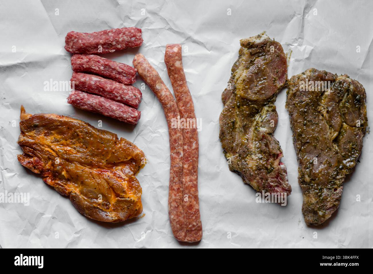 Different types of meat on shiny paper Stock Photo - Alamy