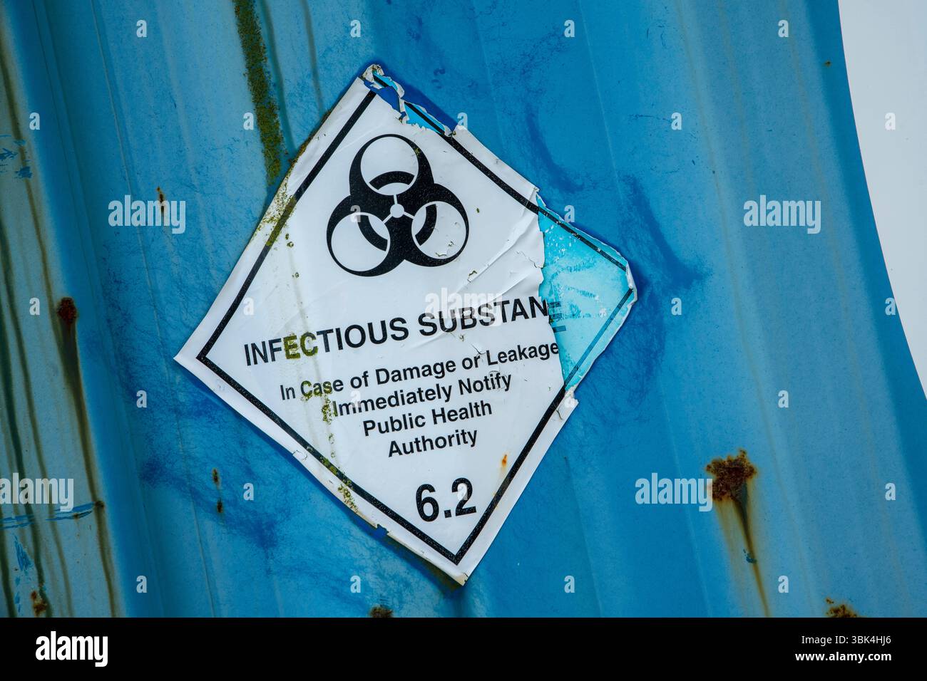 Weathered and peeling infectious substance sticker featuring a ...