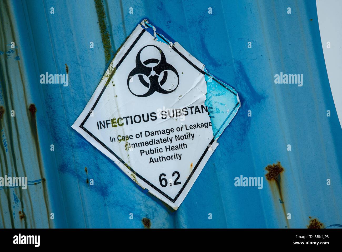 Weathered and peeling infectious substance sticker featuring a ...