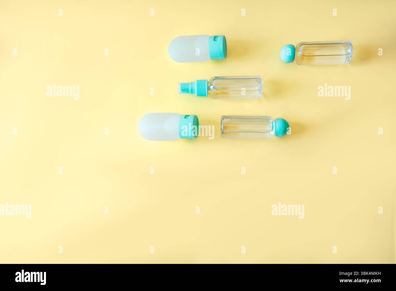 Symmetrical arrangement of transparent and silicone cosmetic bottles on ...