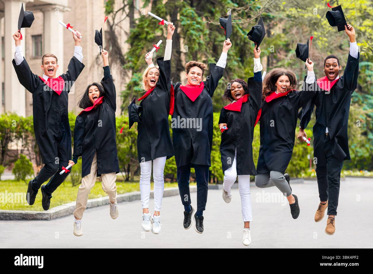 Happy students celebrating graduation from university, jumping up Stock ...
