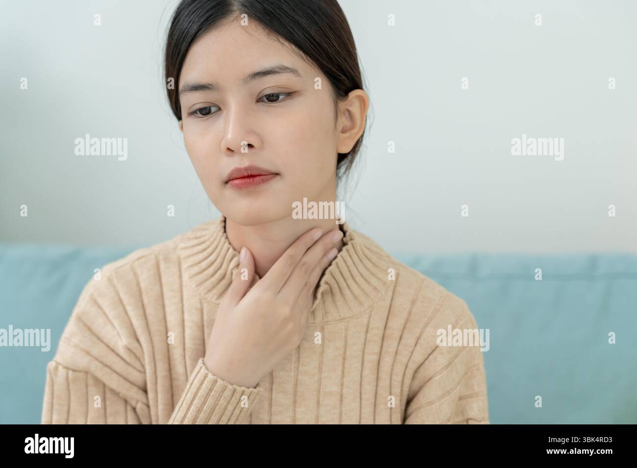 Asian woman put on neck due to a sore throat. female tonsillitis causes ...