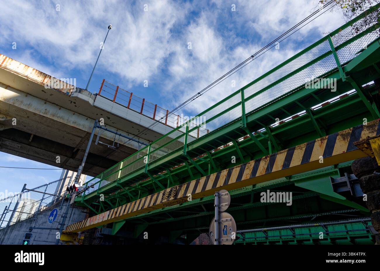 Overlapping expressway and railway bridges in Shin-Ōkubo, framed by sky ...