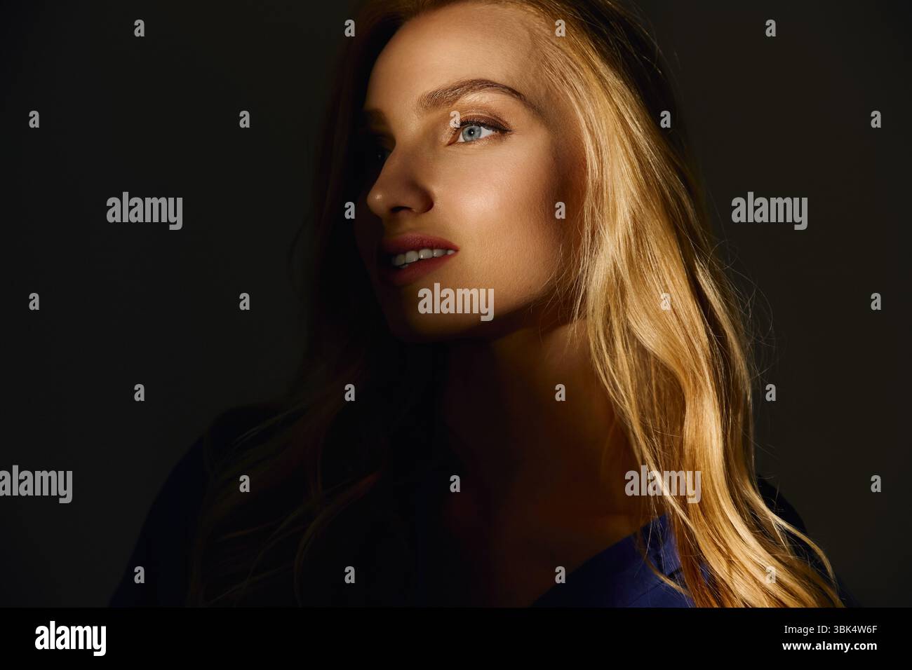 A stylish young woman displays her beauty and playful spirit in soft ...