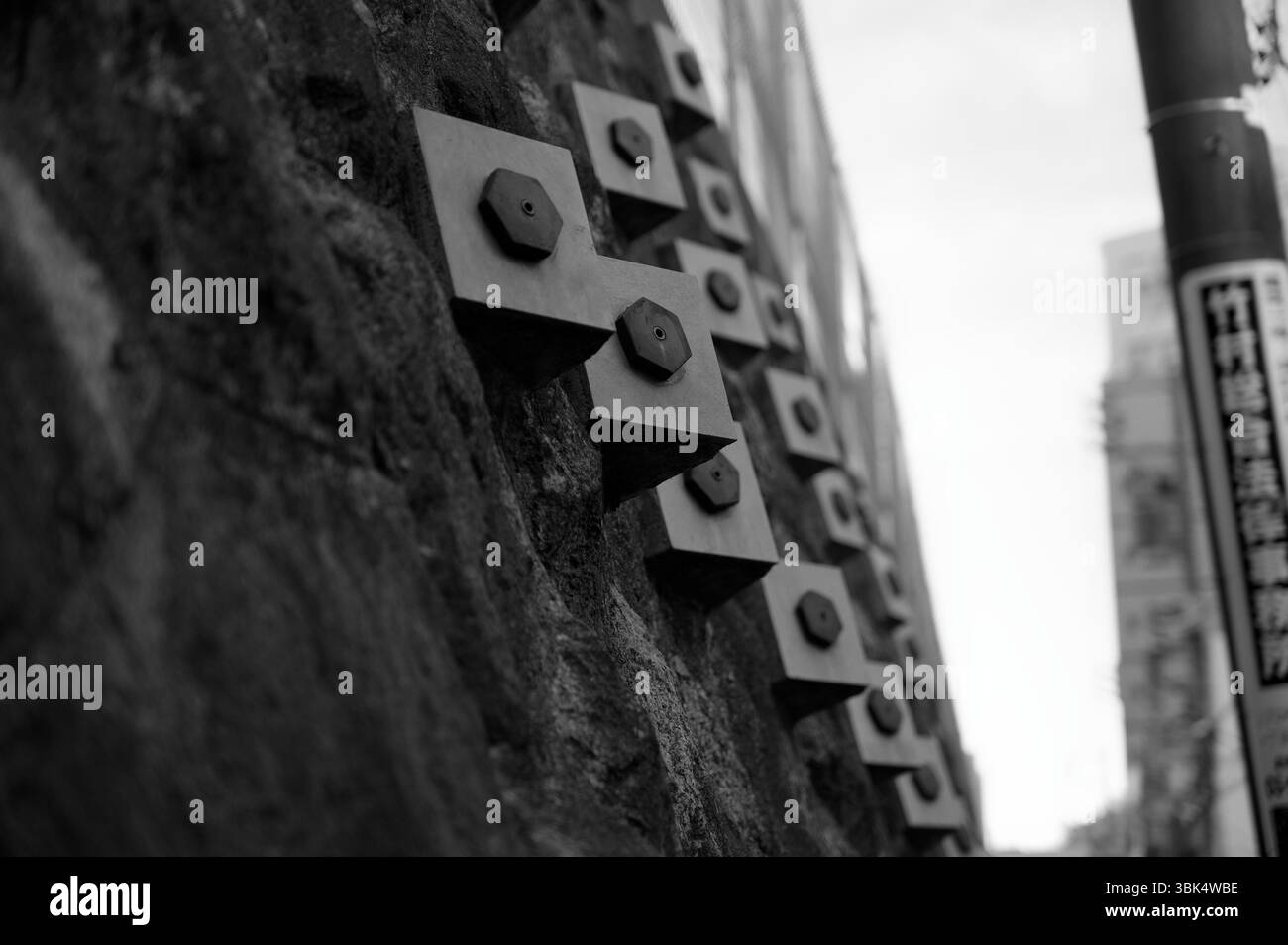 Heavy steel anchors secure a stone retaining wall for an elevatted ...