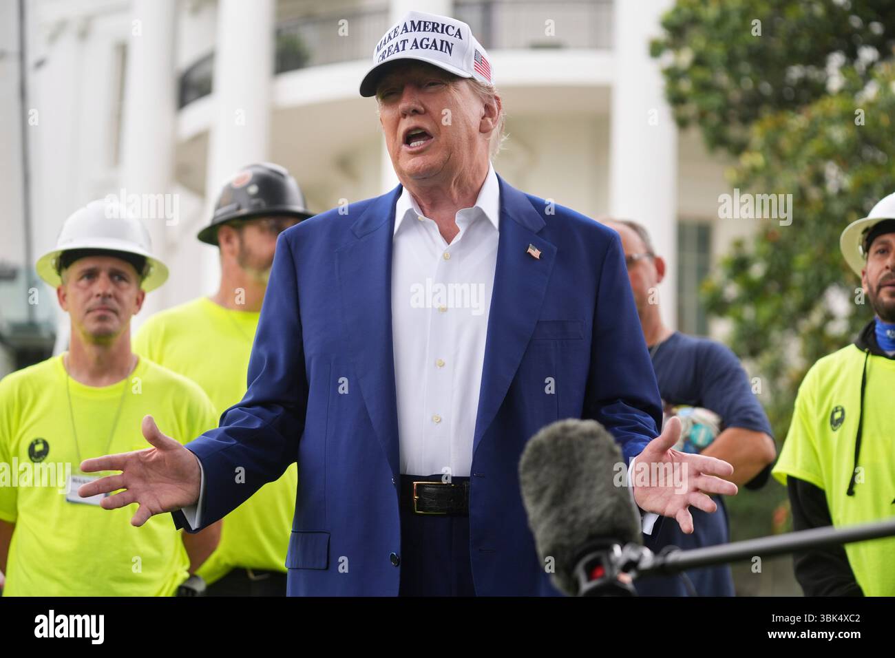 President Donald Trump speaks as a flag pole is installed on the South ...