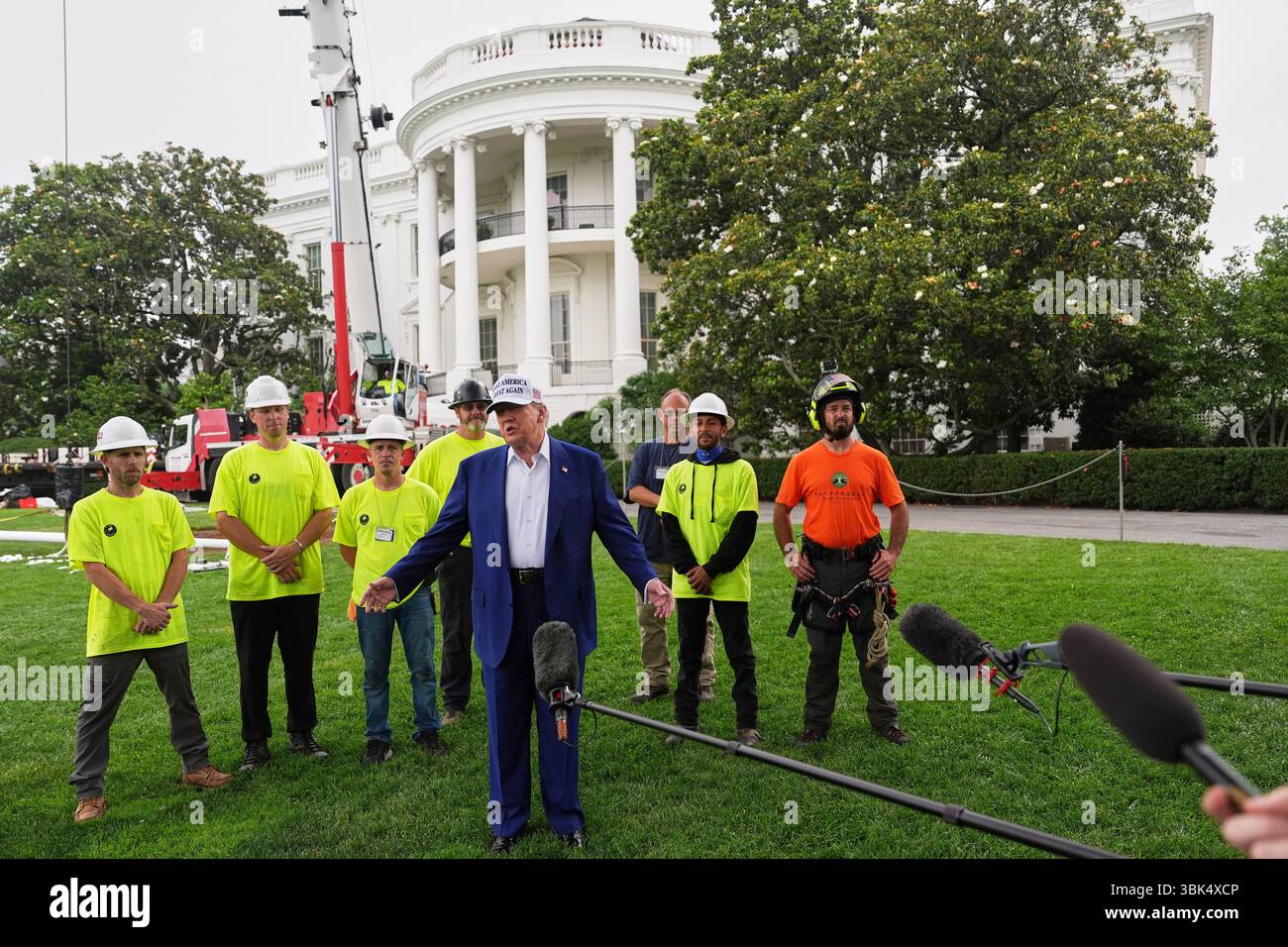 President Donald Trump speaks as a flag pole is installed on the South ...
