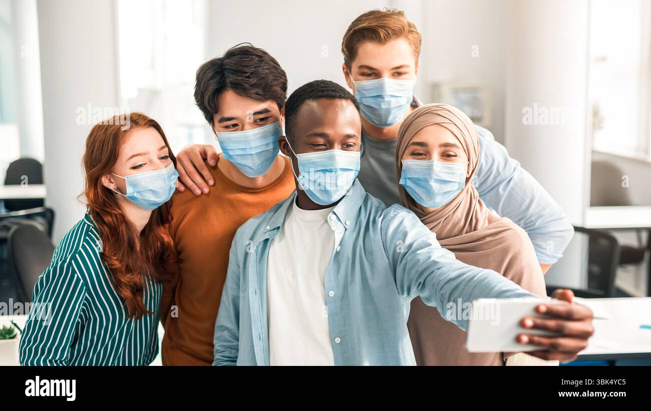 International students wearing medical masks taking selfie Stock Photo ...