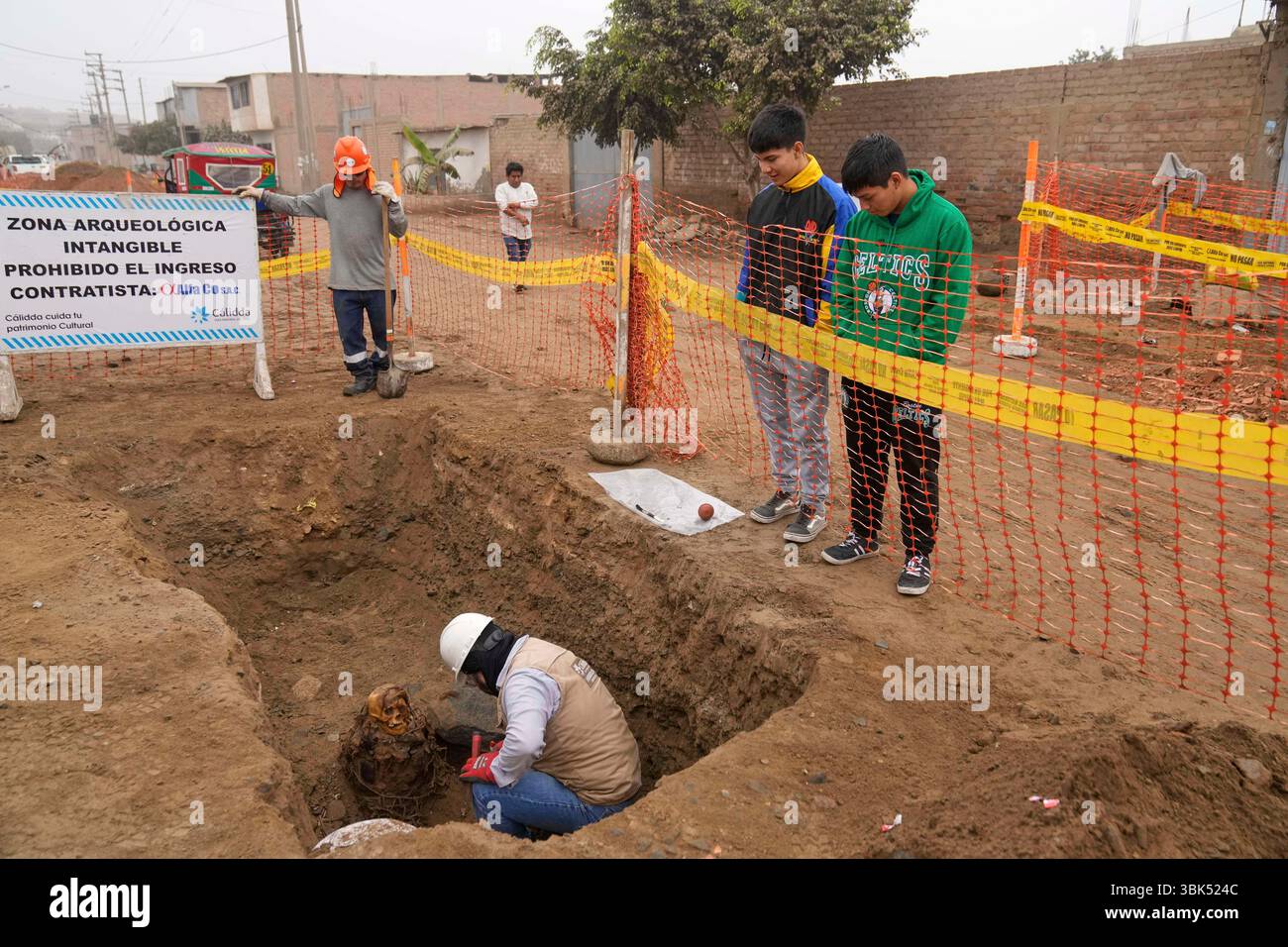 Archaeologist Jose Aliaga excavates an ancient mummy, which he said is ...