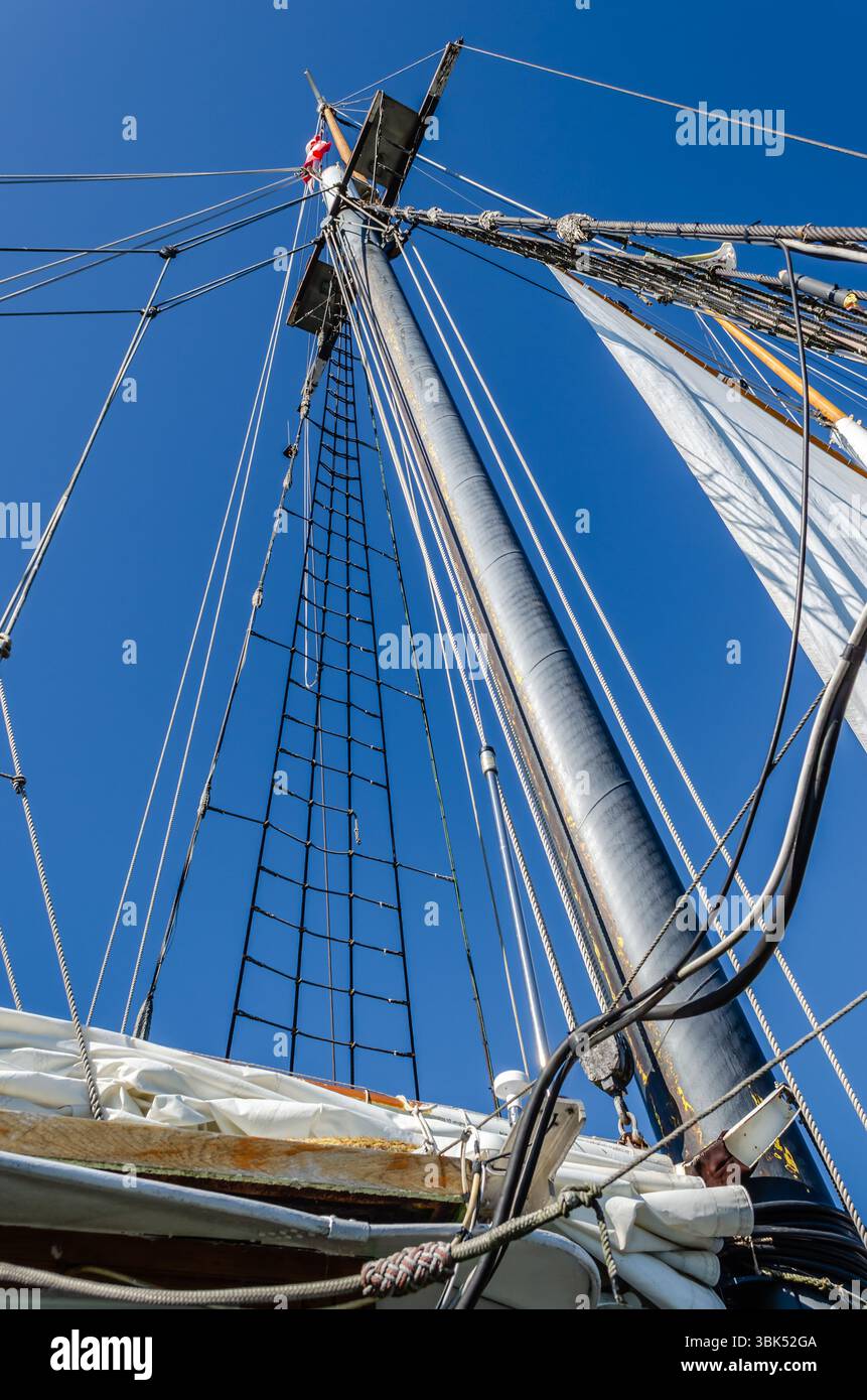 Vertical view to the top of a Tall Ship mast with Canadian flag against ...