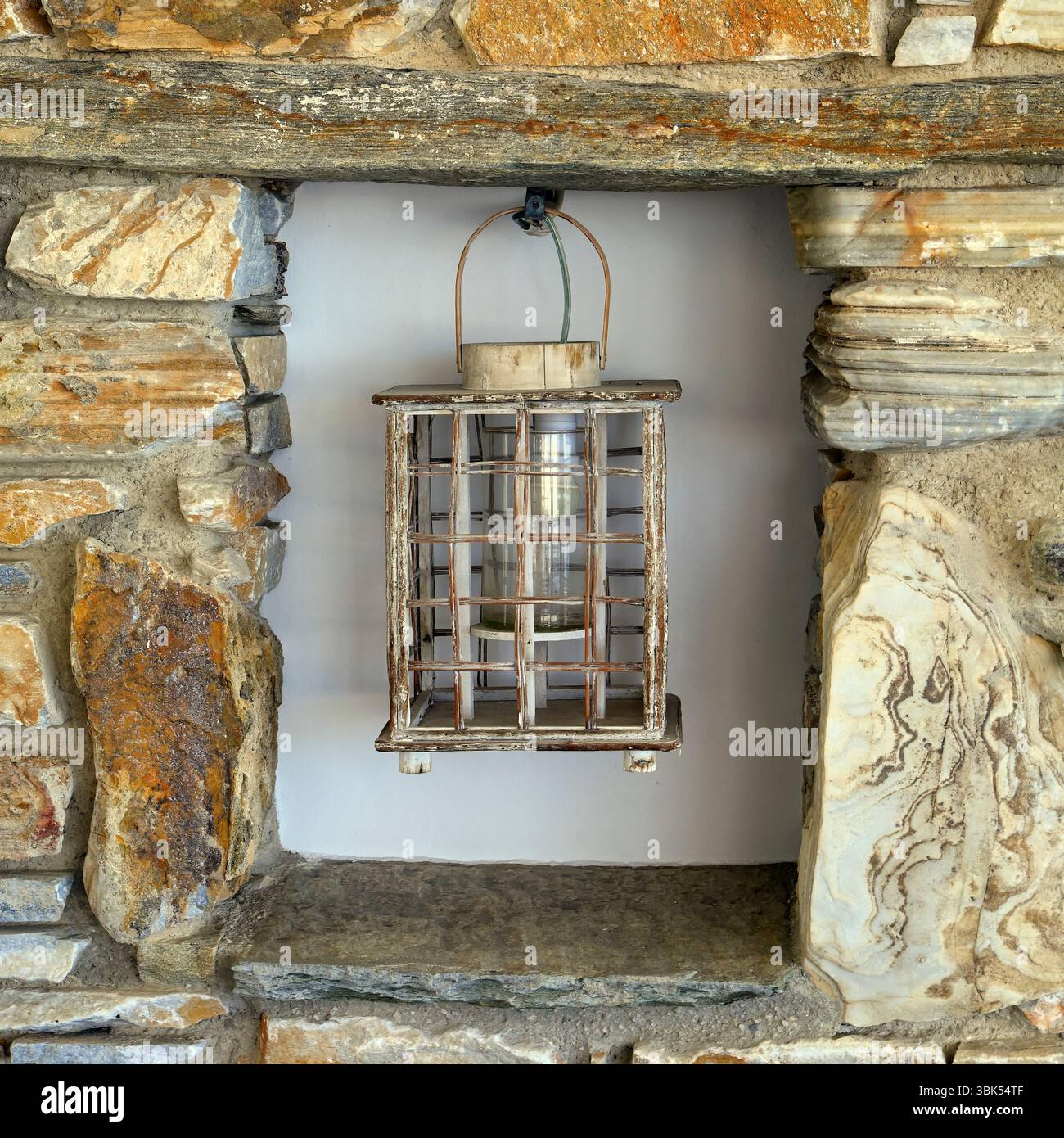 Decorative lamp inset into a stone wall, Greece. Taken June 2025 summer ...