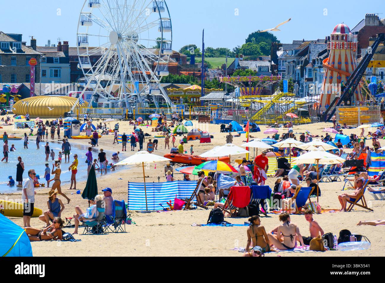 Weymouth, Dorset, UK. 18th June, 2025. UK Weather: Sunseekers flock to ...