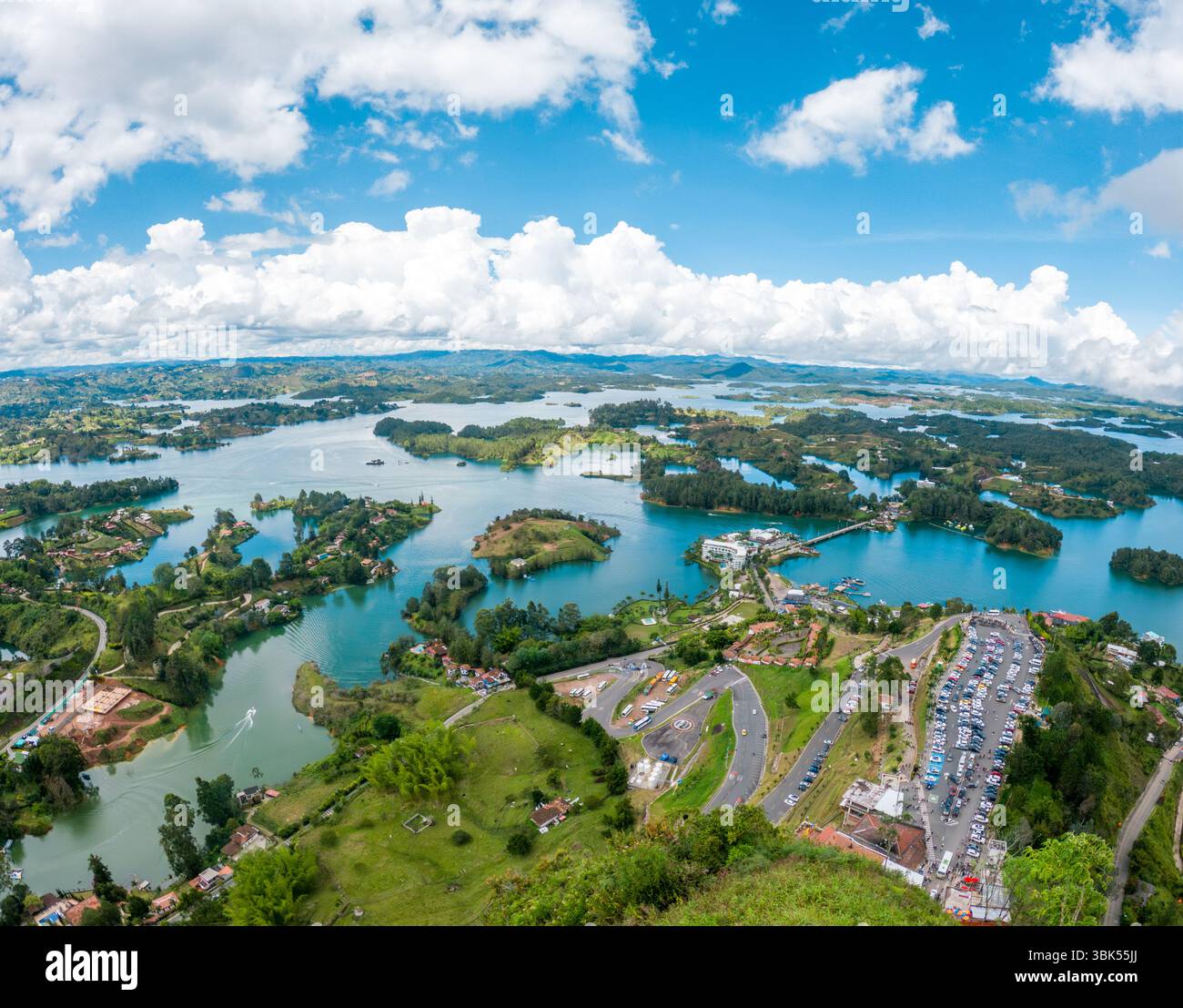 Breathtaking aerial view of Guatape, showcasing lush green hills and ...