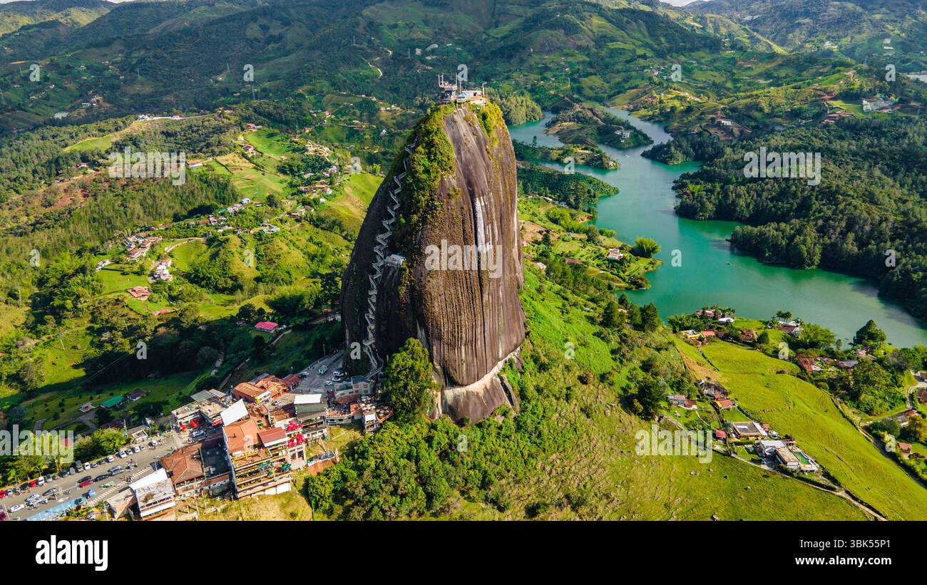 Stunning aerial view of El Peñol rock surrounded by lush greenery and a ...