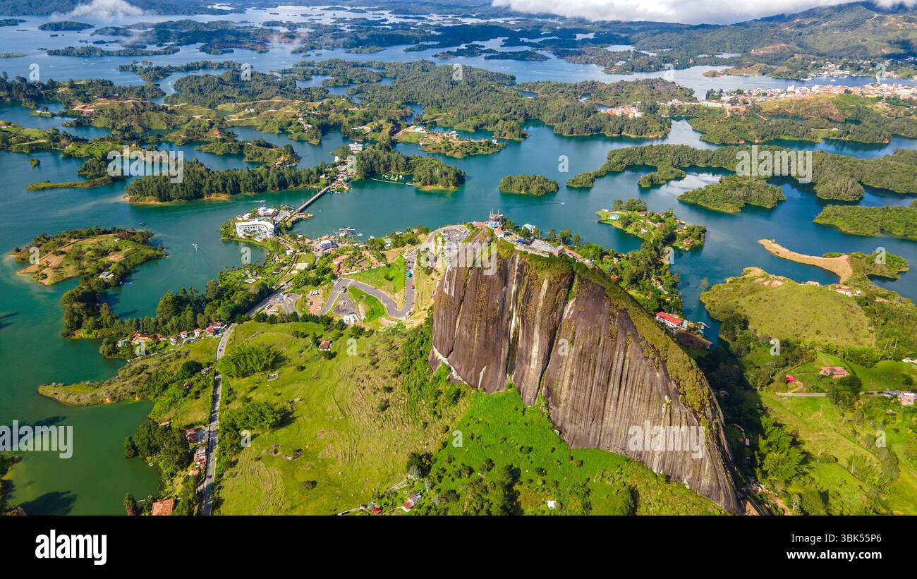 Stunning aerial view of El Peñol rock surrounded by lush green ...