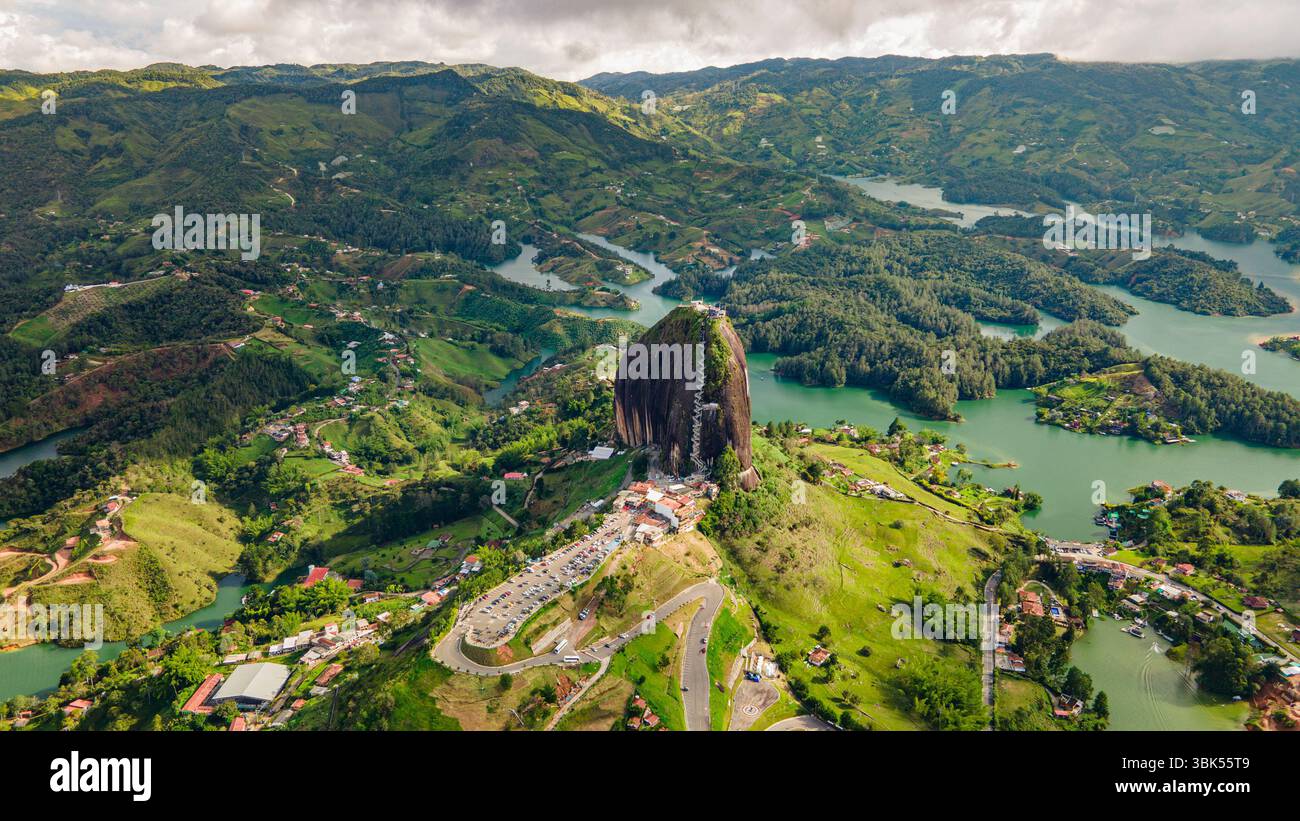 Breathtaking aerial view of El Peñol rock formation surrounded by lush ...