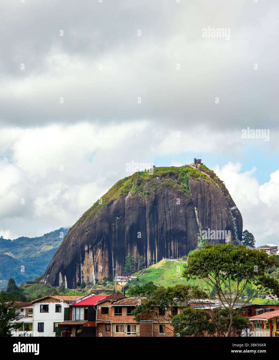 A stunning view of the Peñol Stone, surrounded by lush green hills and ...