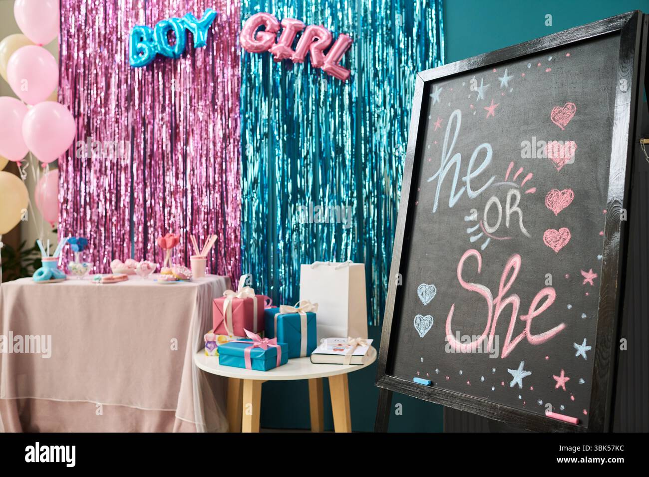 Decorated gender reveal party scene featuring table with sweets ...