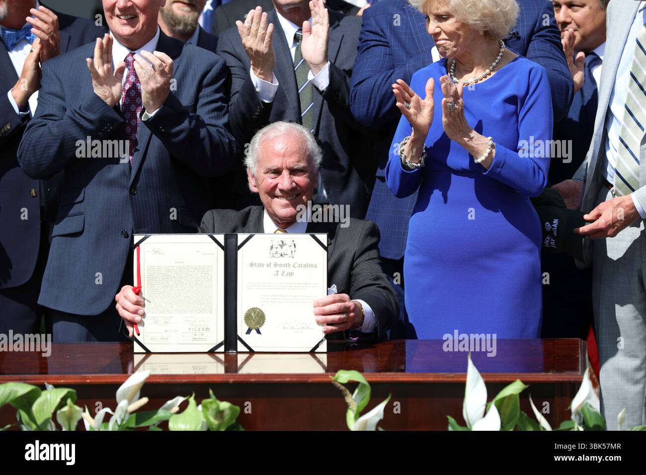 Republican South Carolina Gov. Henry McMaster holds up a ceremonial ...
