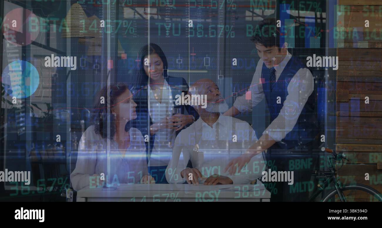 Collaborating team meeting around wheelchair user at modern office desk, with stock market ...