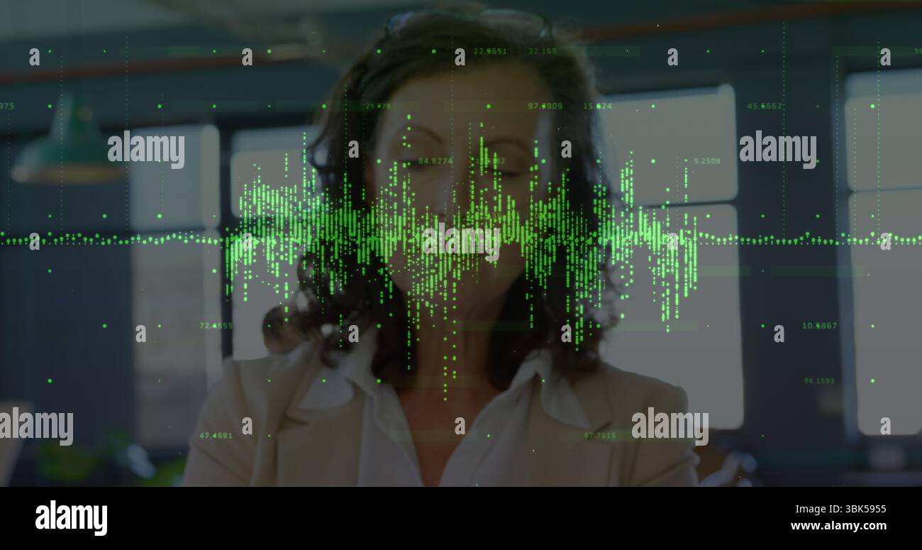 Analyzing woman interpreting holographic data display in office, with green waveform and numbers ...