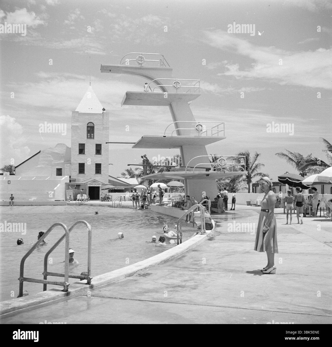 Hotel in Miami Beach, with guest standing by the swimming pool and the ...